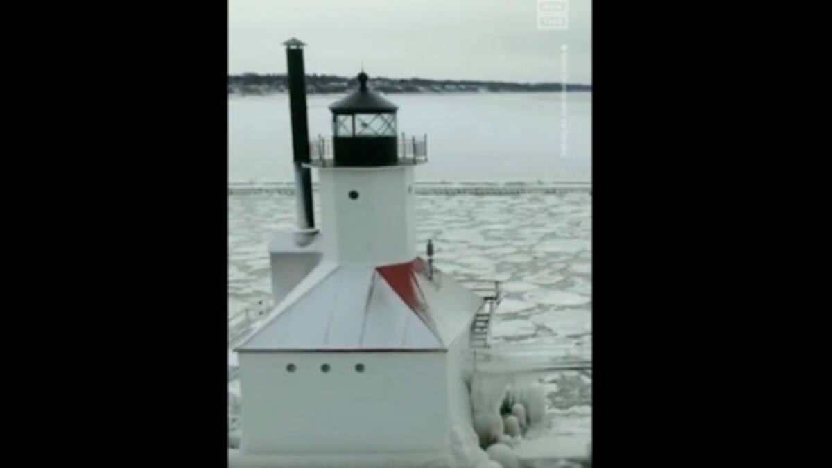 Watch: Lighthouse and surrounding pier in Lake Michigan shrouded in ice ...
