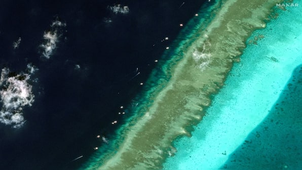 Satellite images reveal floating barrier at mouth of disputed atoll in ...