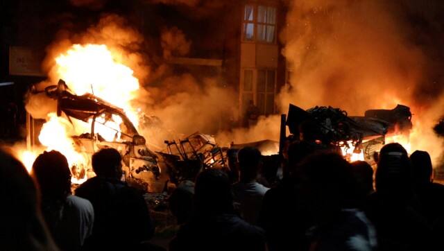 Police cars flipped, bus on fire: What's behind the riots in UK's Leeds ...