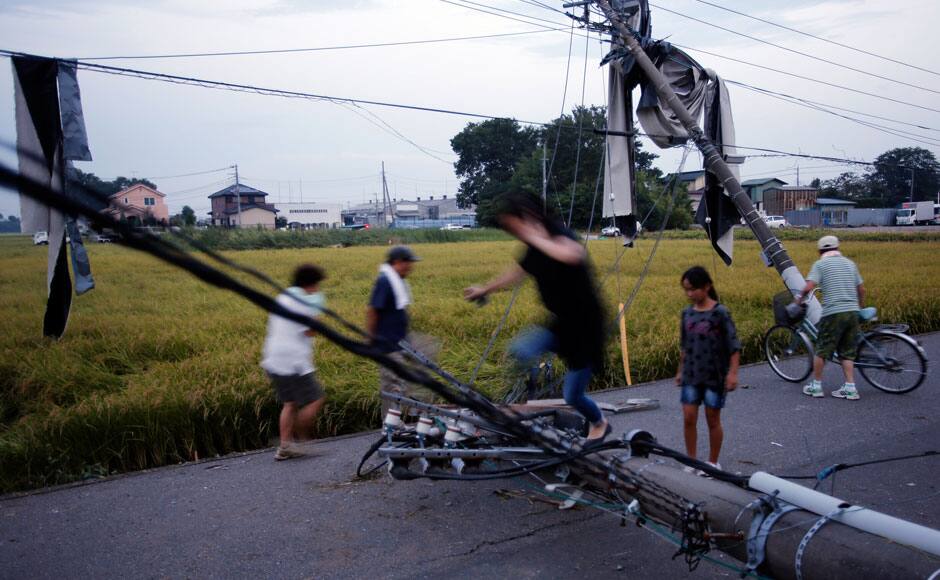 Photos: Upturned cars, destroyed houses as tornado rips through Japan ...