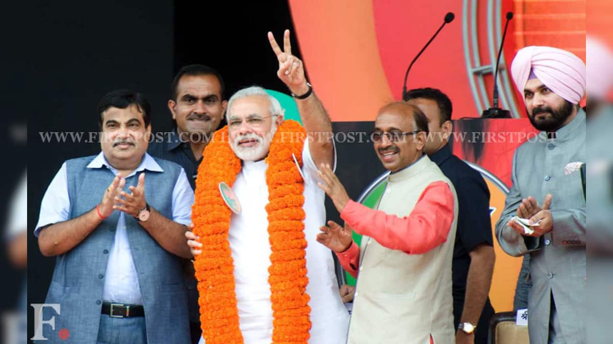 Photos: Narendra Modi woos audience at BJP Delhi rally – Firstpost