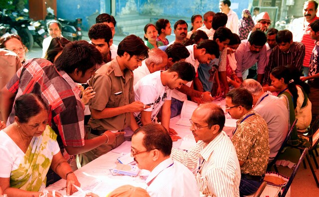 Photos: In Delhi, voters line up early morning outside poll booths ...