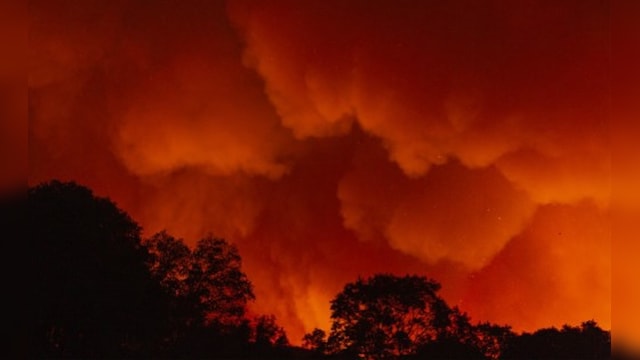 California Skies Glow Orange As Firefighters Battle Wildfires That Rage